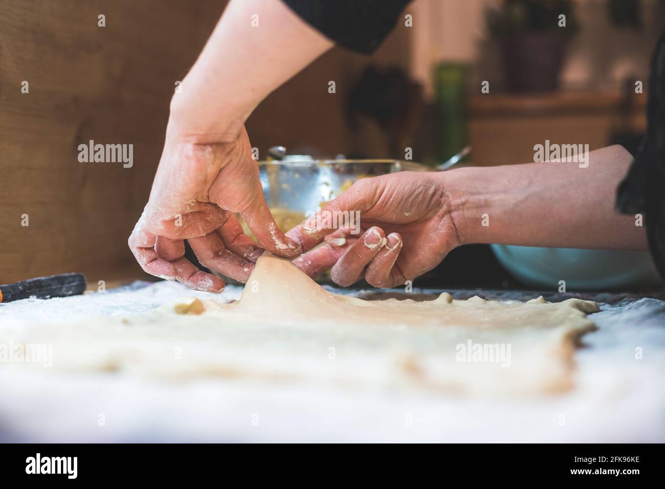Close up of woman rolling traditional dough in the kitchen Stock Photo ...