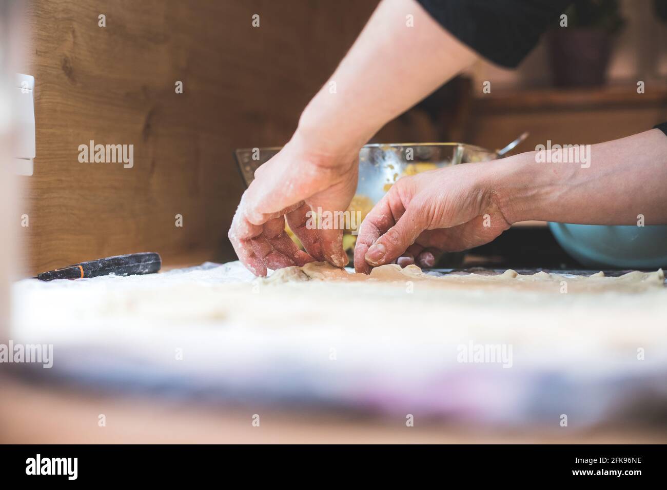 Close up of woman rolling traditional dough in the kitchen Stock Photo ...