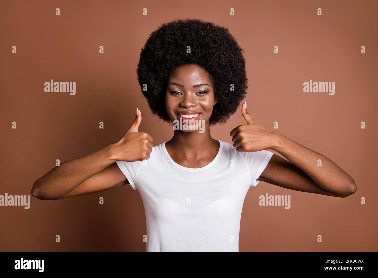 Photo portrait of girl showing thumb-up gesture both hands in white t ...