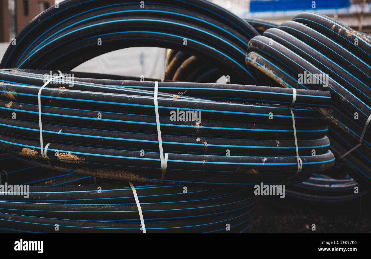 black plastic cables on a construction site Stock Photo - Alamy