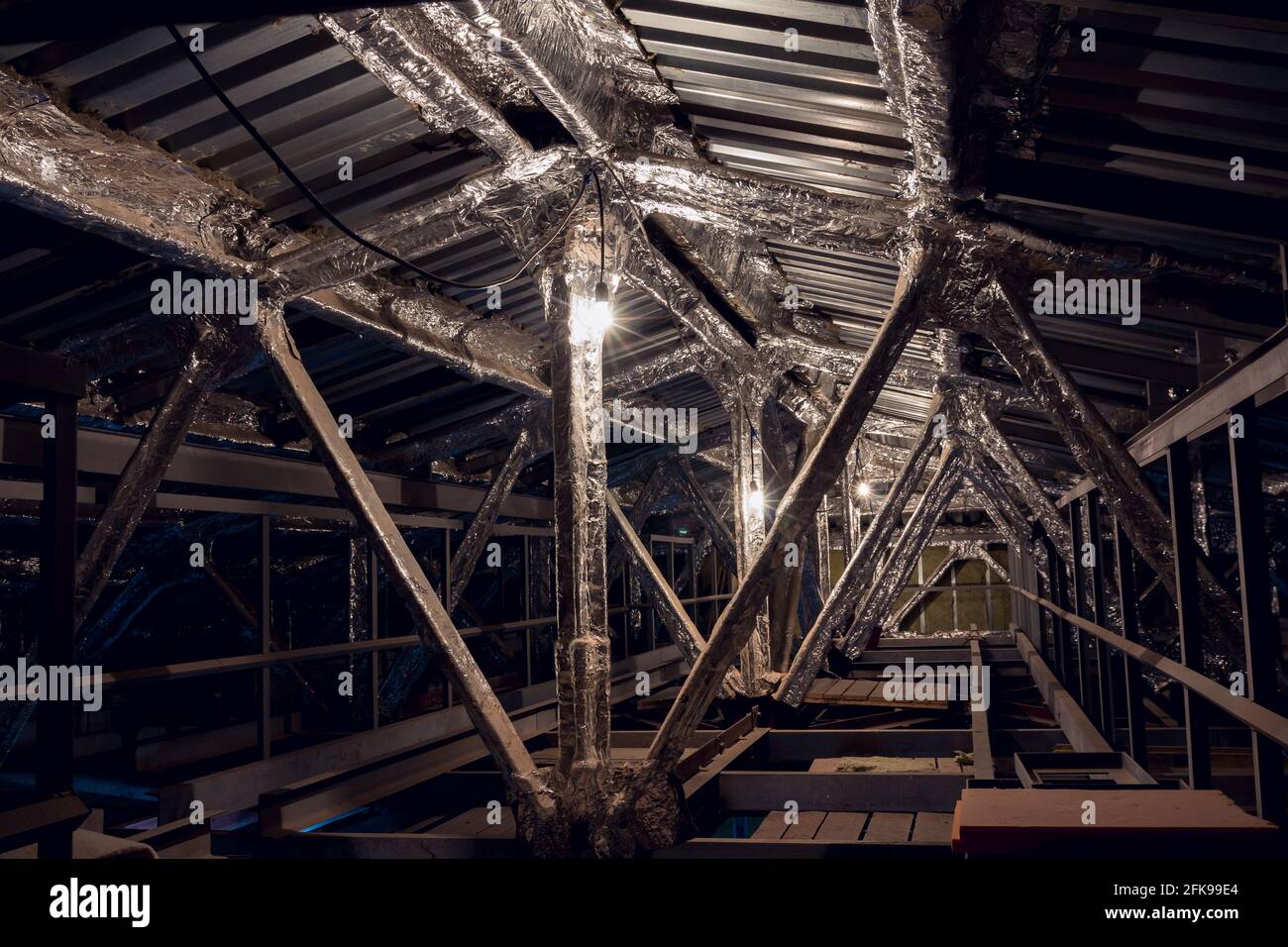 Foil insulation. Insulation of the steel frame of the building with ...