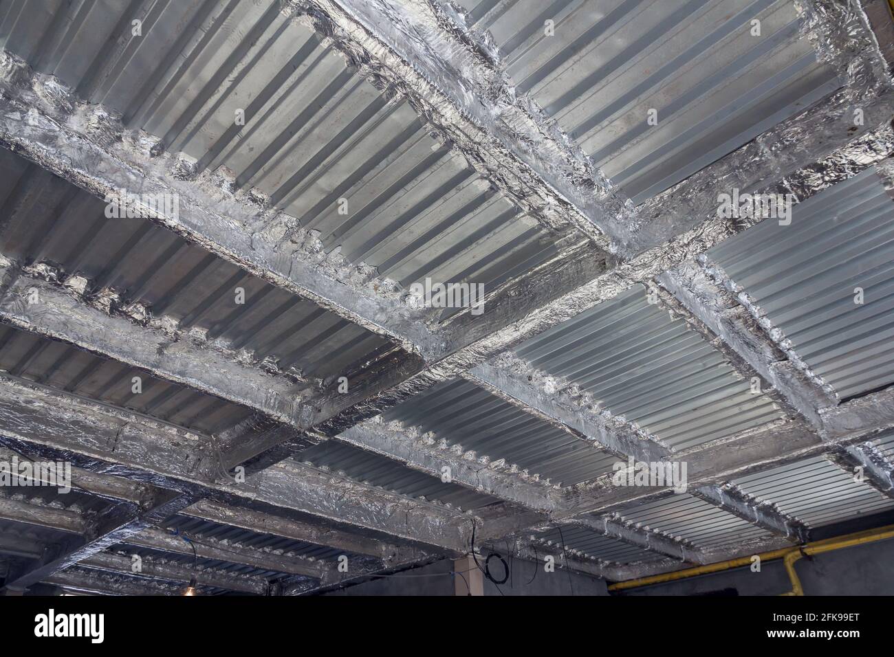 Foil insulation. Insulation of the steel frame of the building with ...