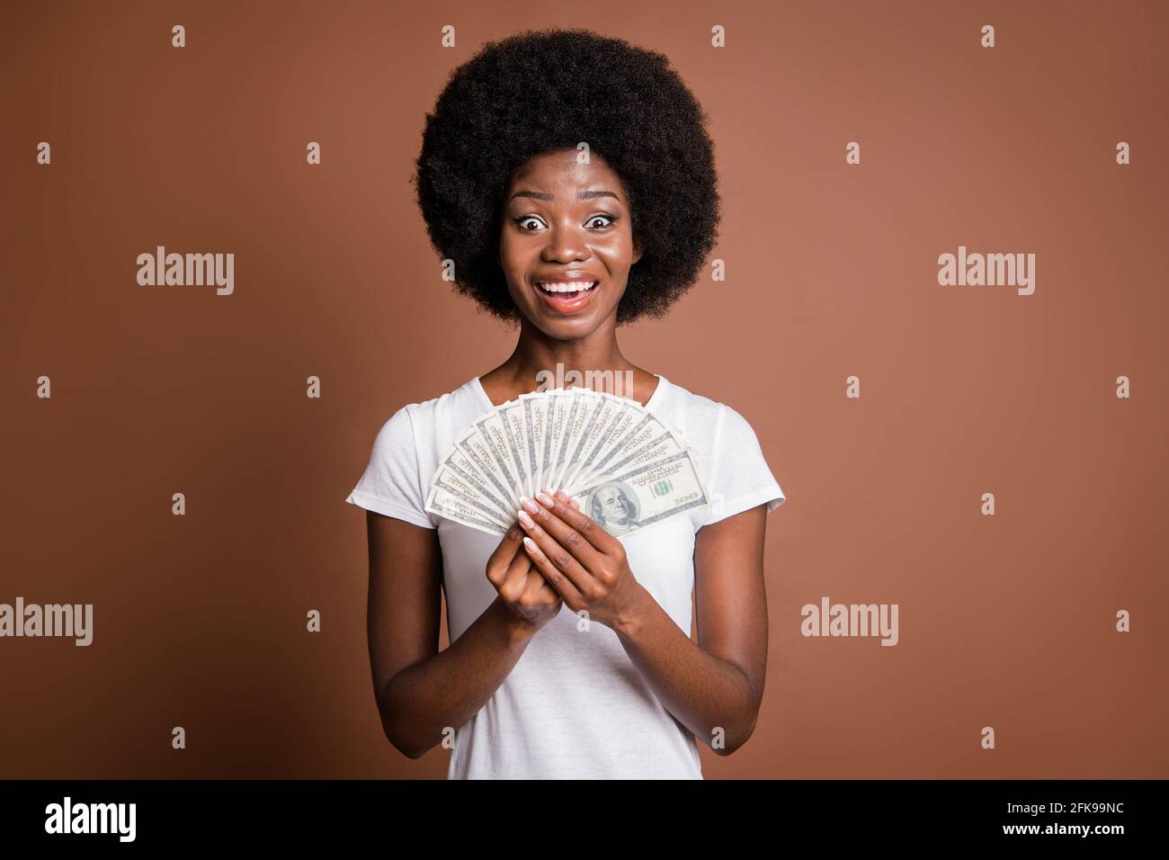 Photo portrait of woman showing money cash dollar banknotes smiling ...