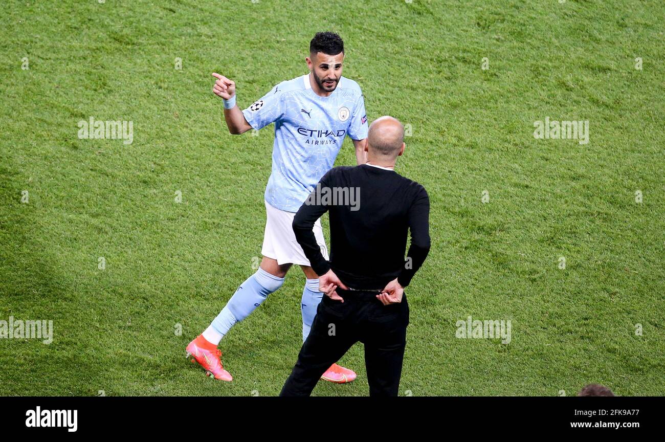 Riyad Mahrez of Manchester City talks to coach of Manchester City Pep ...