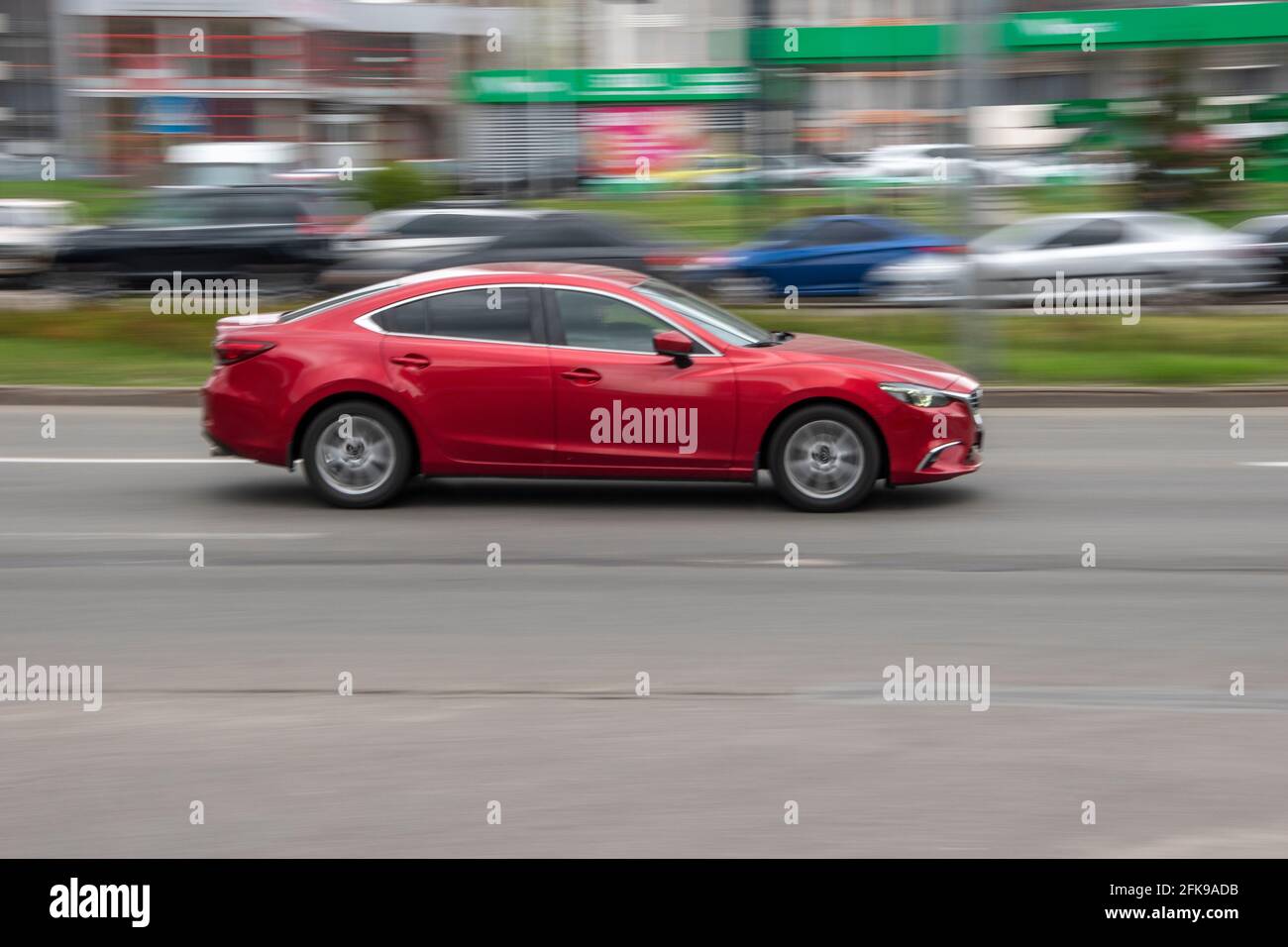Ukraine, Kyiv - 20 April 2021: Red KIA Cerato car moving on the street ...