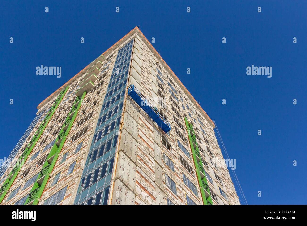 Construction suspended cradle. Construction cradle with workers on the ...