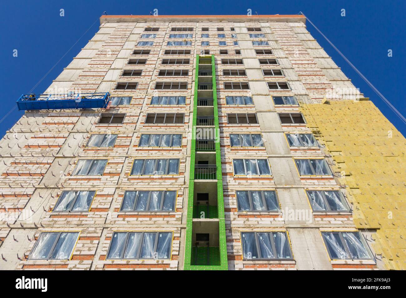 Construction suspended cradle. Construction cradle with workers on the ...