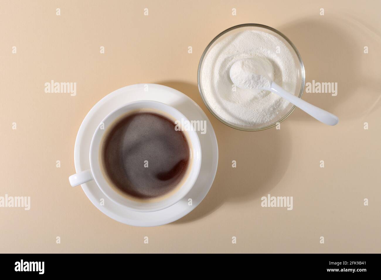 Collagen powder and cup of coffee on beige background. Extra protein ...