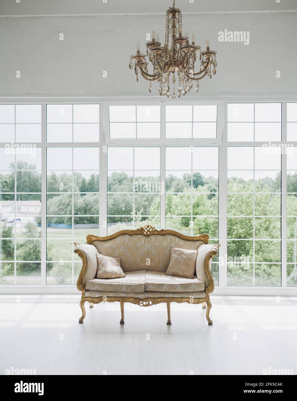 classic interior of the living room with a sofa and a large window ...