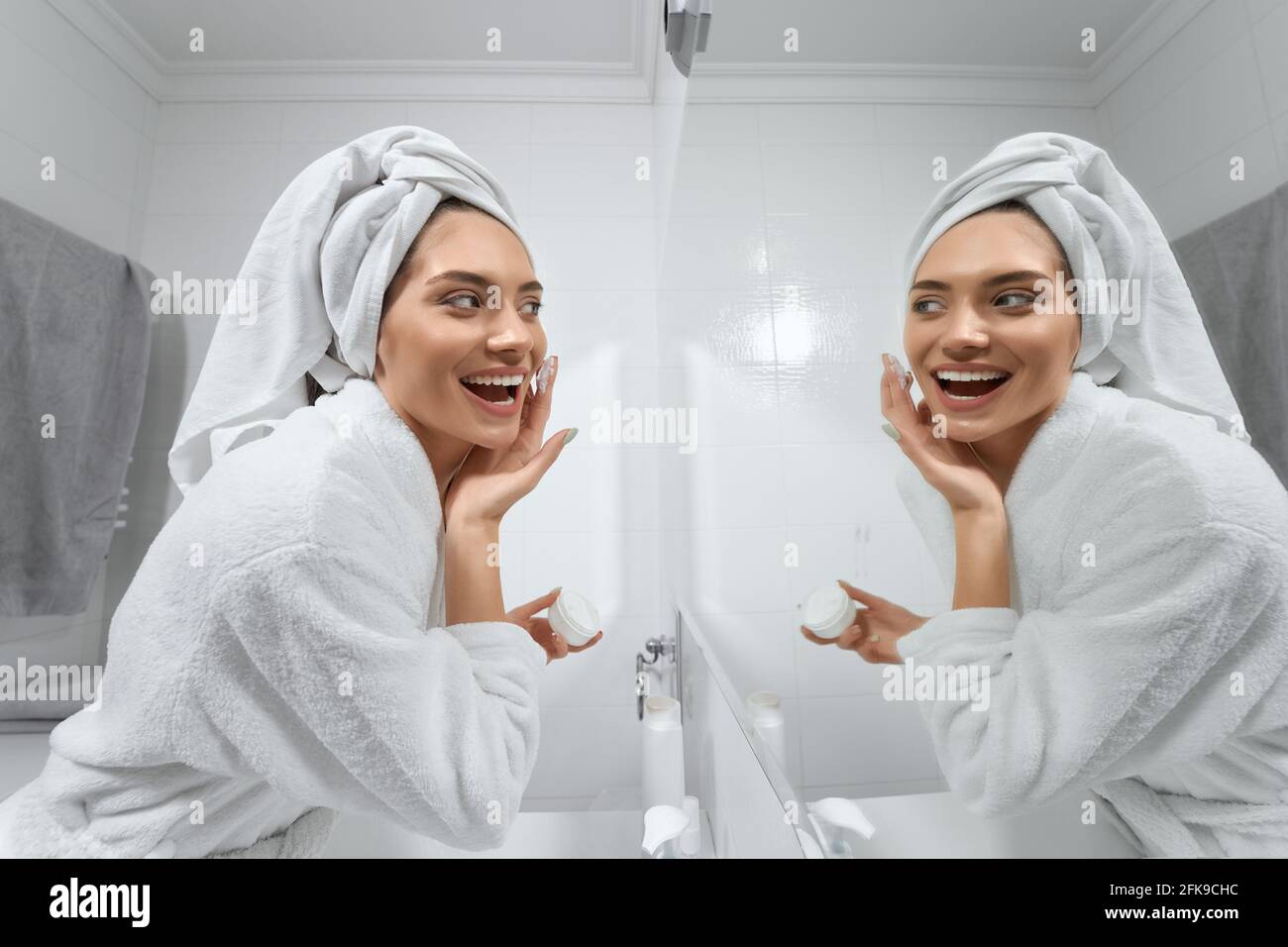 Side view of happy cute young woman preparing go to sleep after shower ...