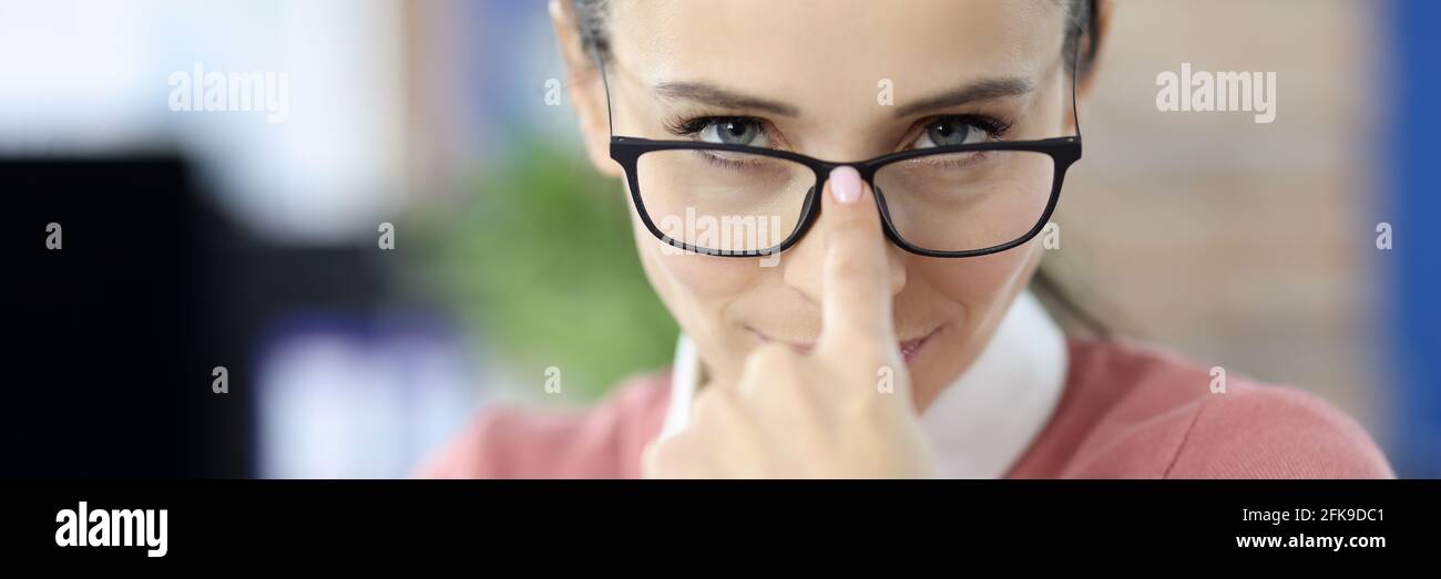 Young woman hand adjusting glasses for vision Stock Photo - Alamy