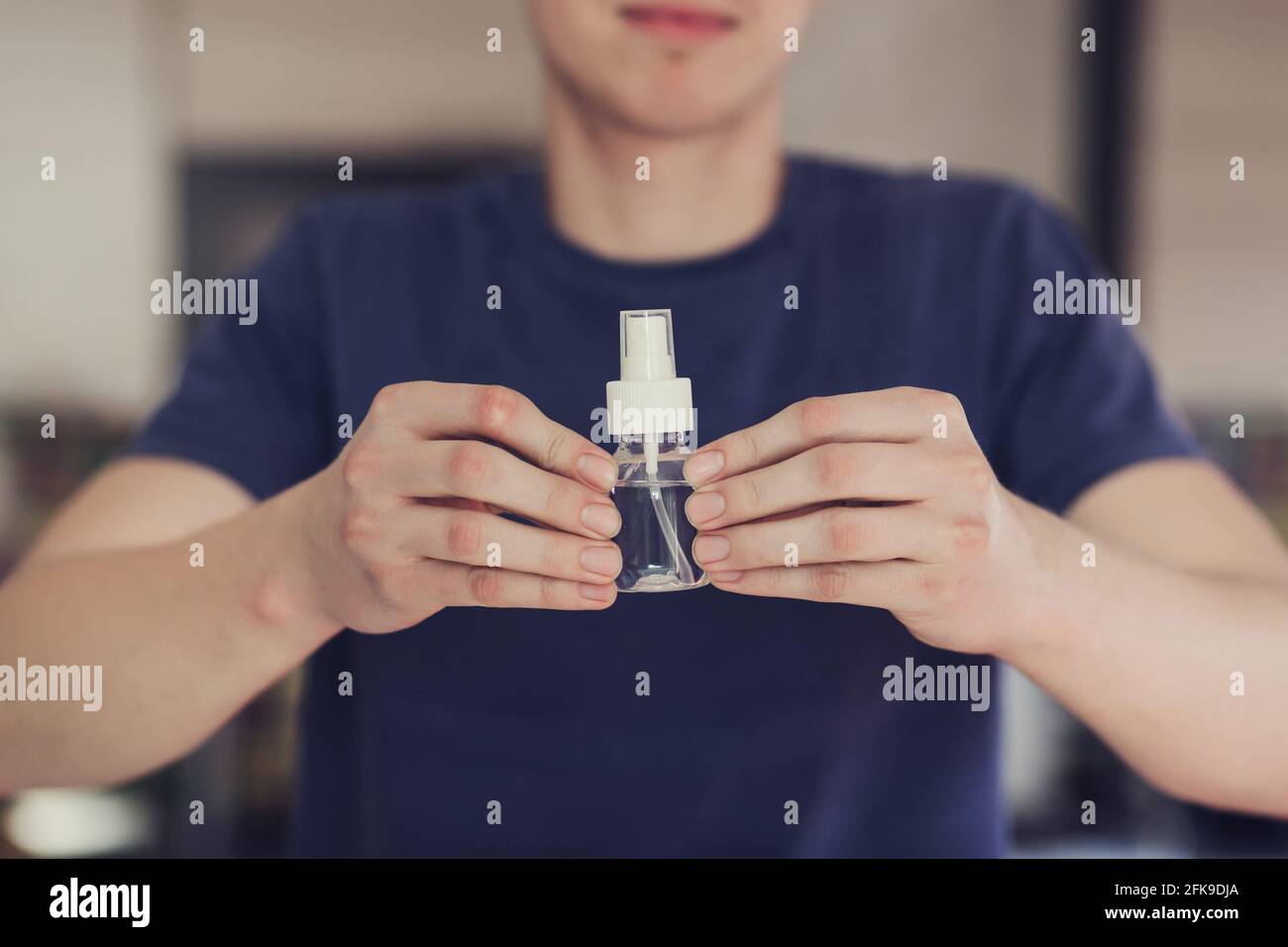 Man holding antiseptic spray to prevent spread of germs, bacteria ...