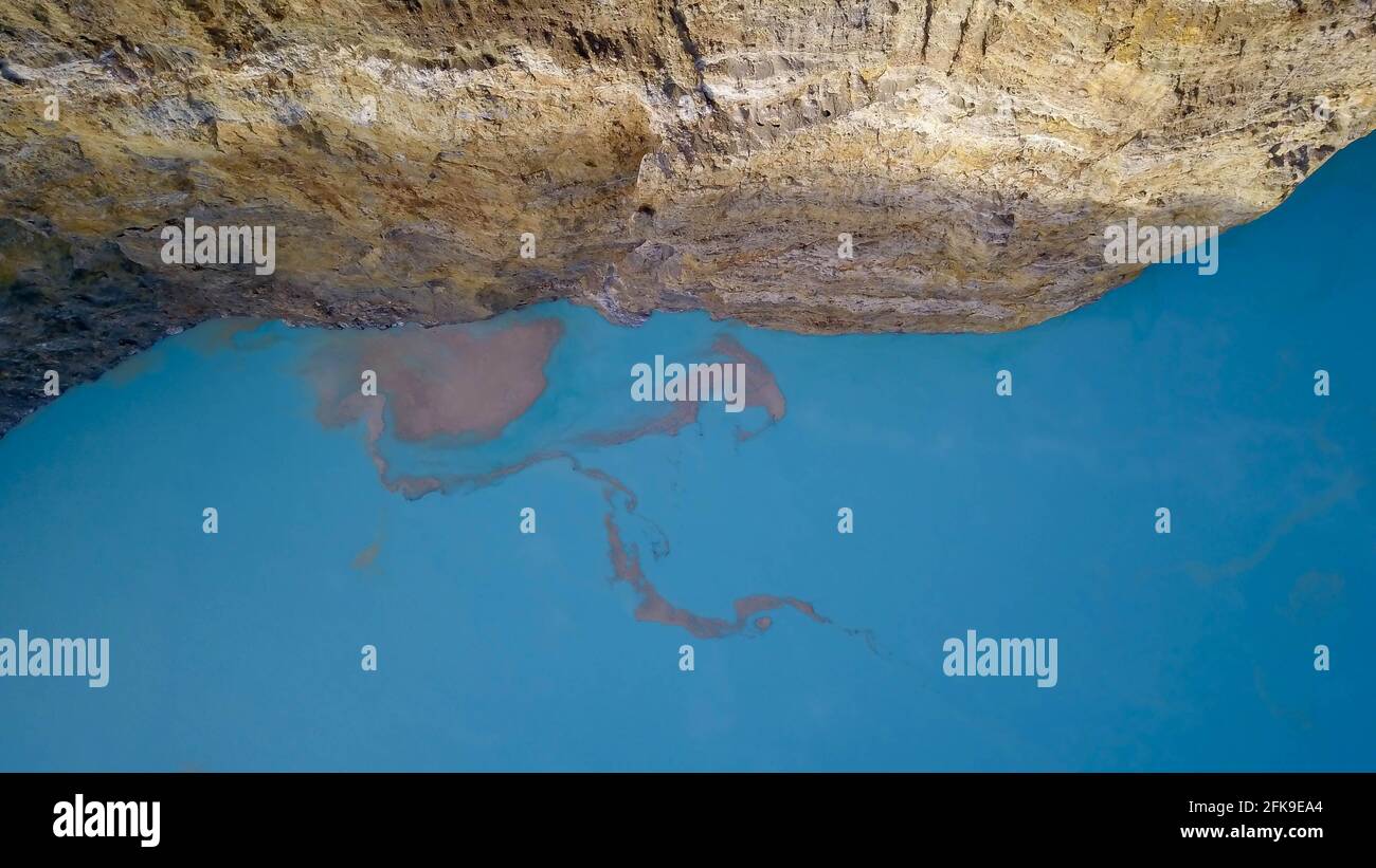 A thin layer of sulfur sediment, floating just below surface of Lake ...