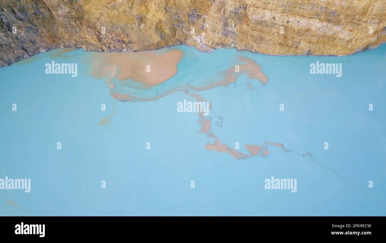 A thin layer of sulfur sediment, floating just below surface of Lake ...