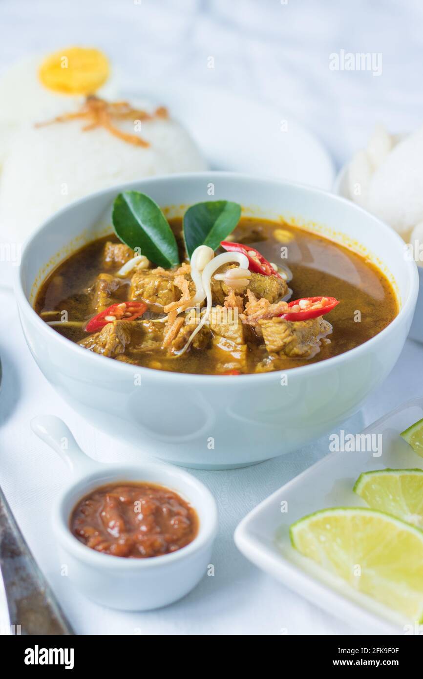 Rawon is traditional Indonesian beef black soup. Served with steam rice ...