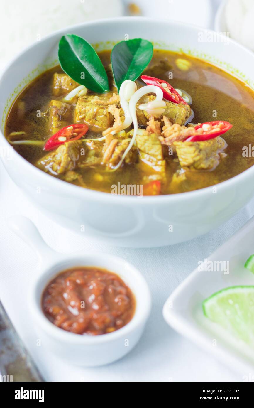 Rawon is traditional Indonesian beef black soup. Served with steam rice ...