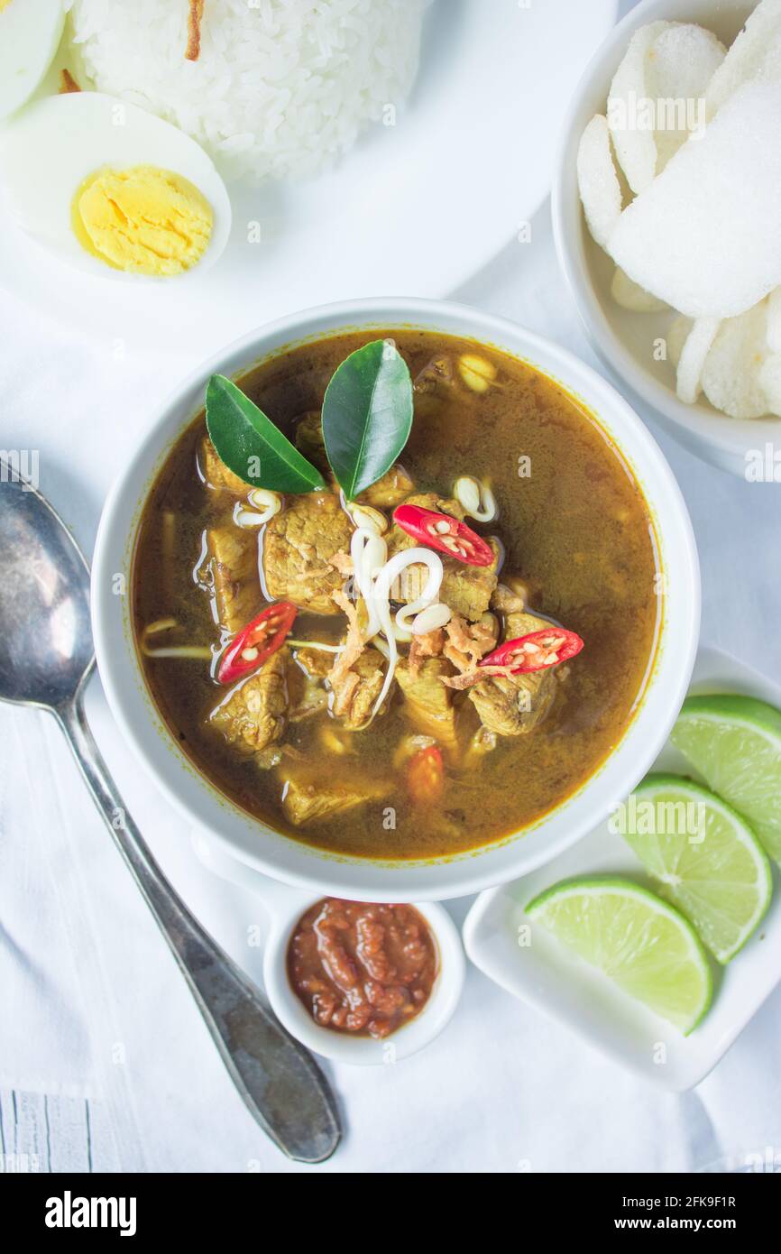 Rawon is traditional Indonesian beef black soup. Served with steam rice ...