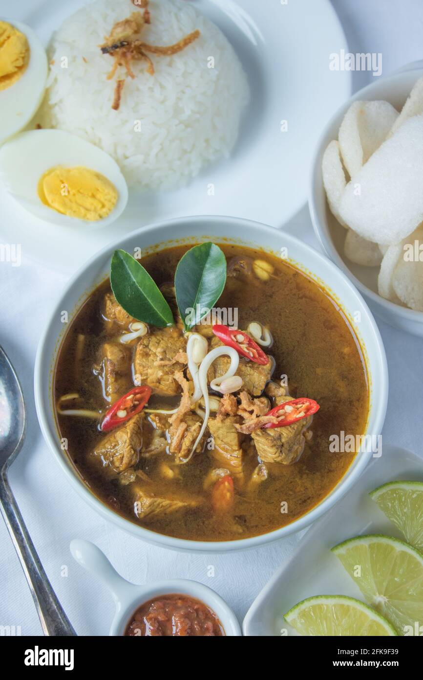 Rawon is traditional Indonesian beef black soup. Served with steam rice ...