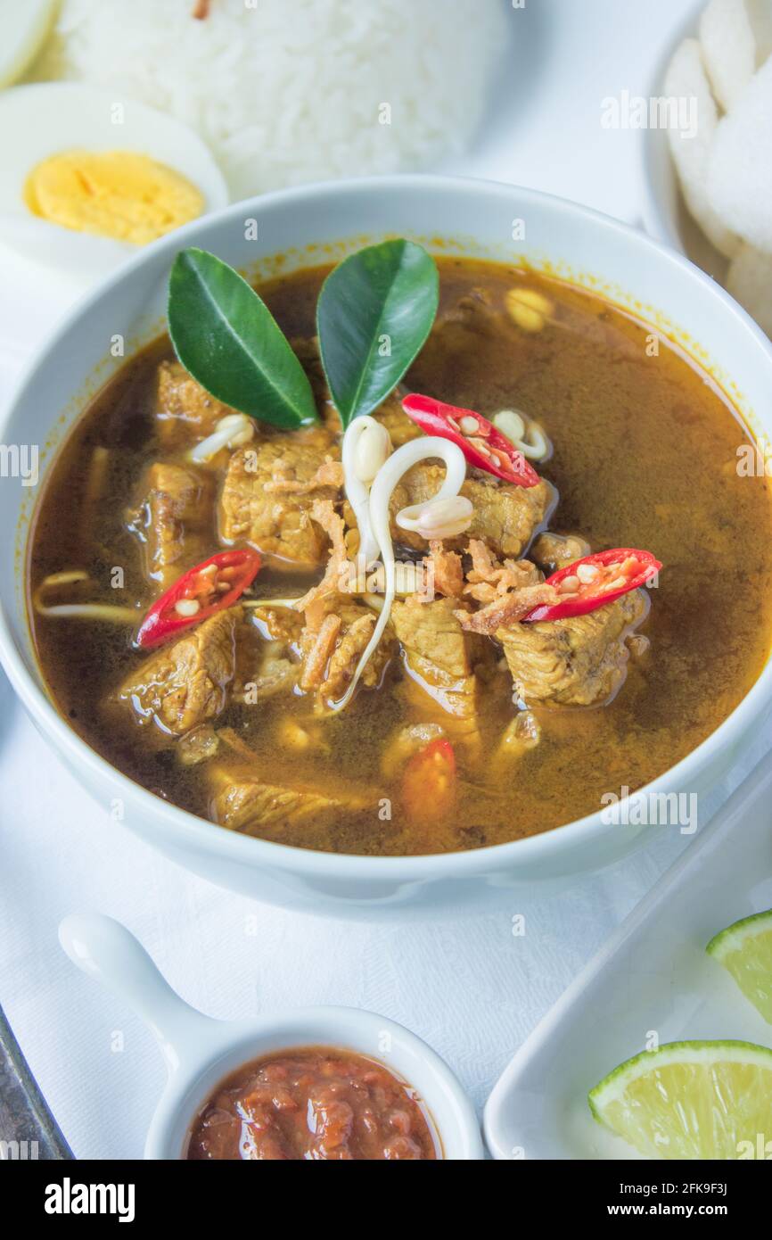 Rawon is traditional Indonesian beef black soup. Served with steam rice ...