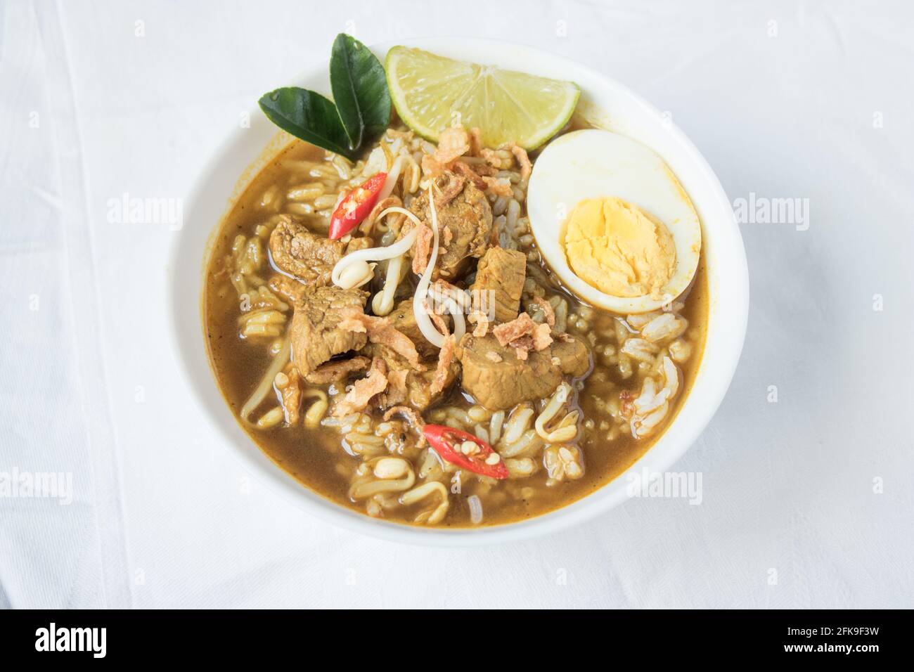 Rawon is traditional Indonesian beef black soup. Served with steam rice ...