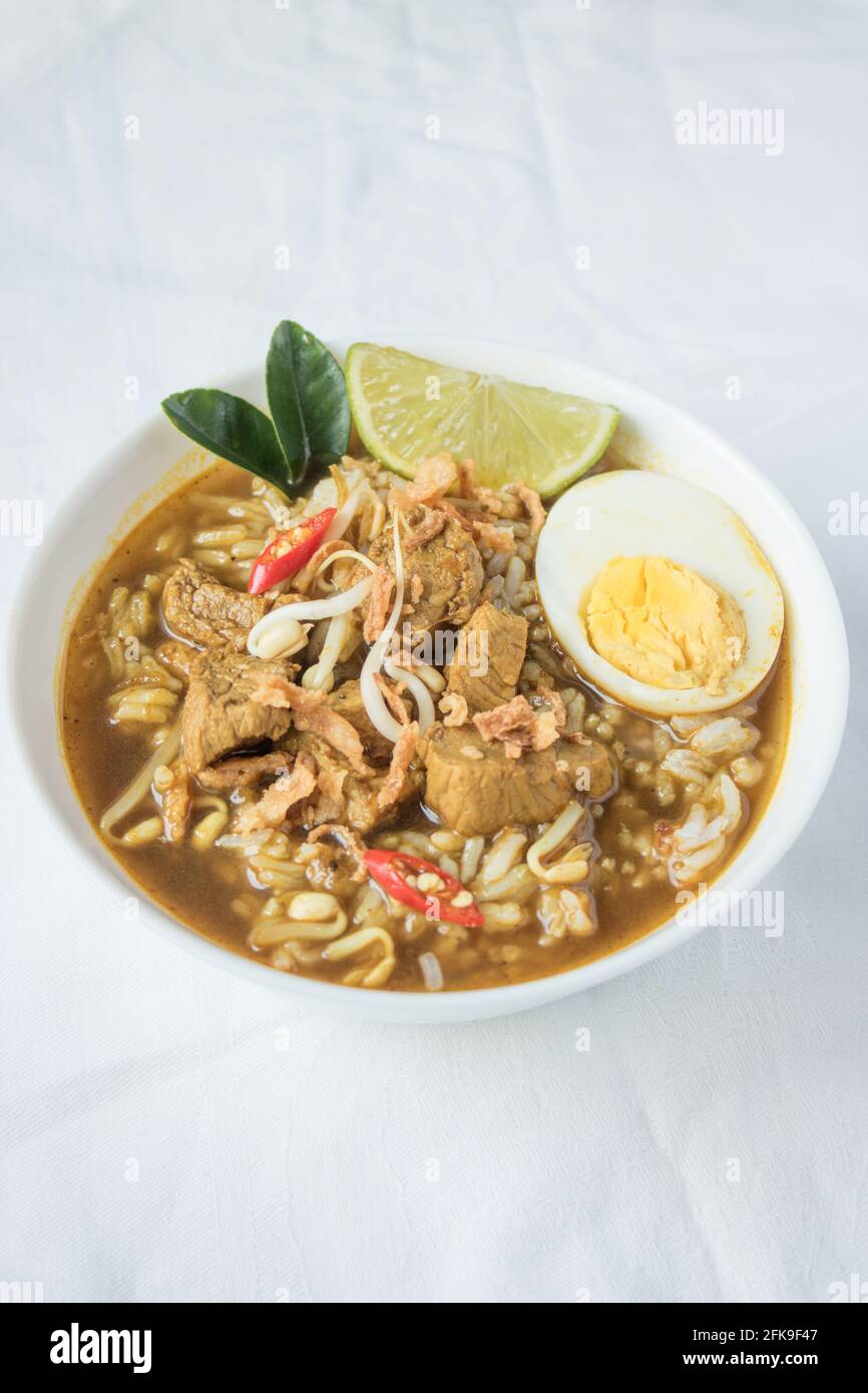 Rawon is traditional Indonesian beef black soup. Served with steam rice ...