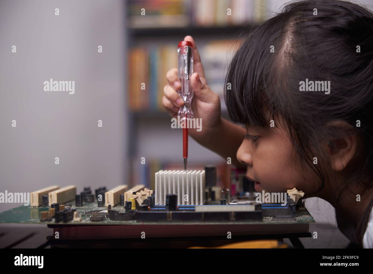Little cute girl playing with broken computer part, kids creativity ...
