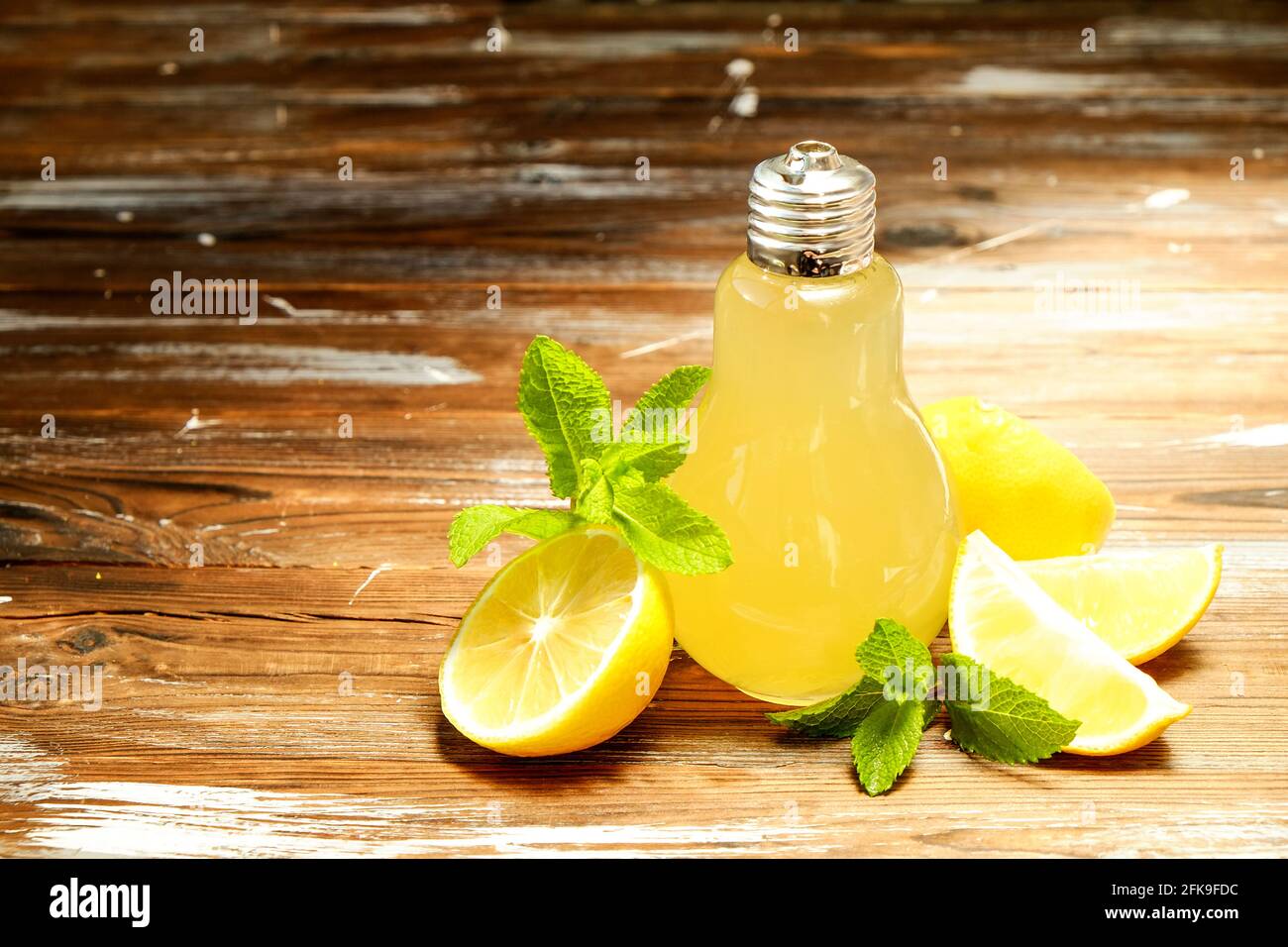 One bulb shaped glass of ice cold homemade lemonade in sun light ...