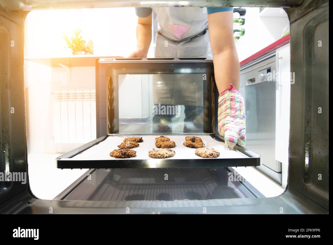 Taking cookies from oven hi-res stock photography and images - Alamy