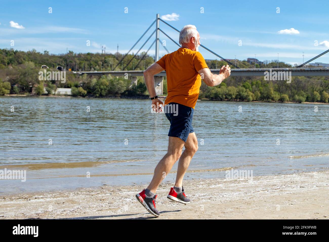 Elderly man running on beach hi-res stock photography and images - Alamy