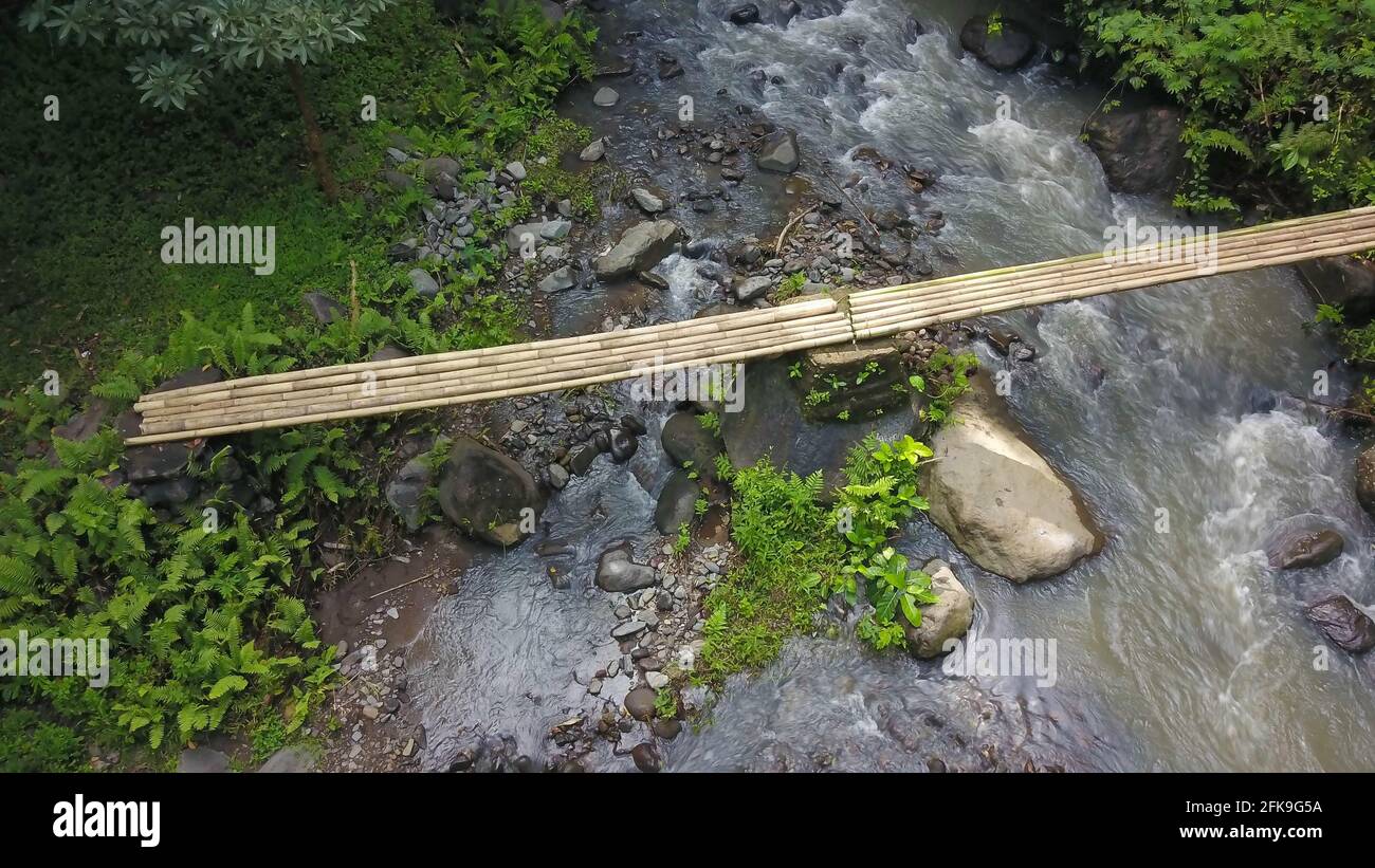 Aerial view to bamboo footbridge over the river. Bamboo bridge across a ...