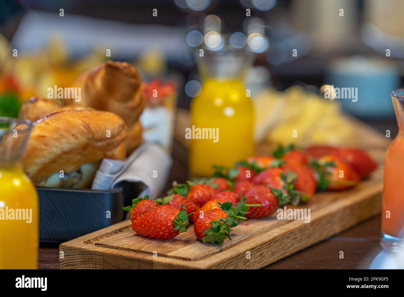 Breakfast buffet served with, orange juice, croissants and strawberry ...