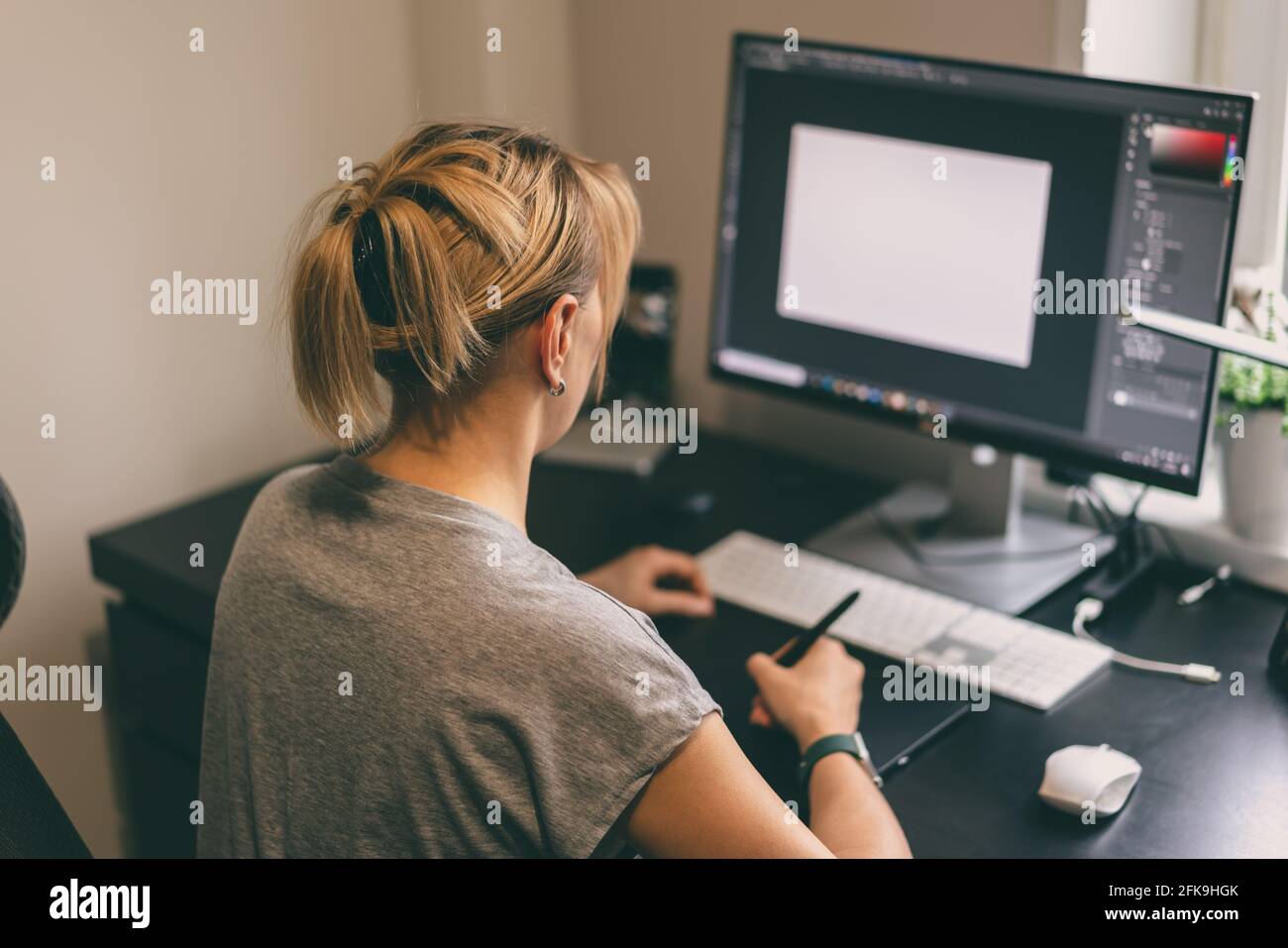 Woman designer, retoucher, photographer or artist drawing something on ...