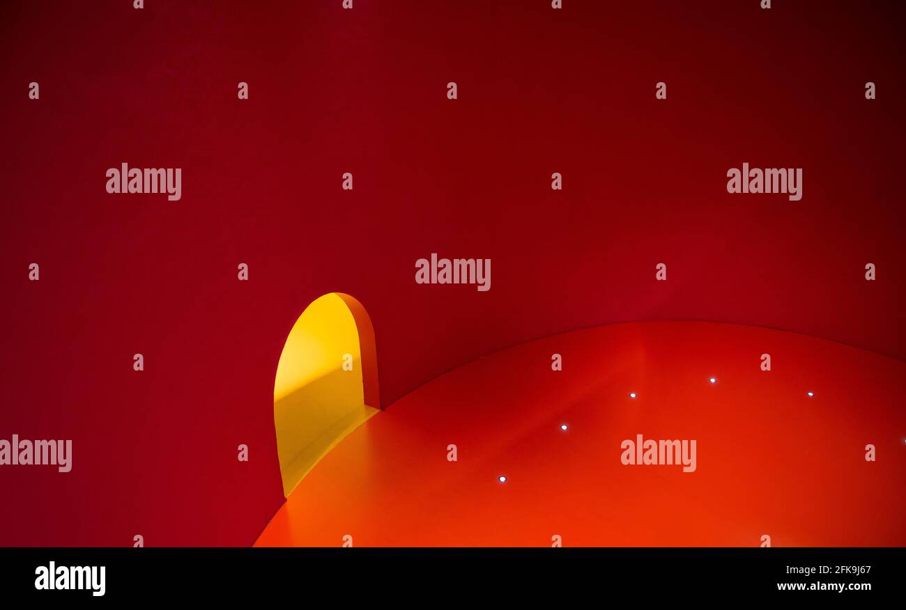 small opening in a red and round room. Yellow wall outside Stock Photo ...