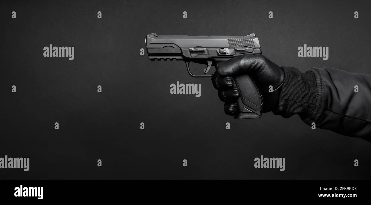 Mans hand holding gun hi-res stock photography and images - Alamy