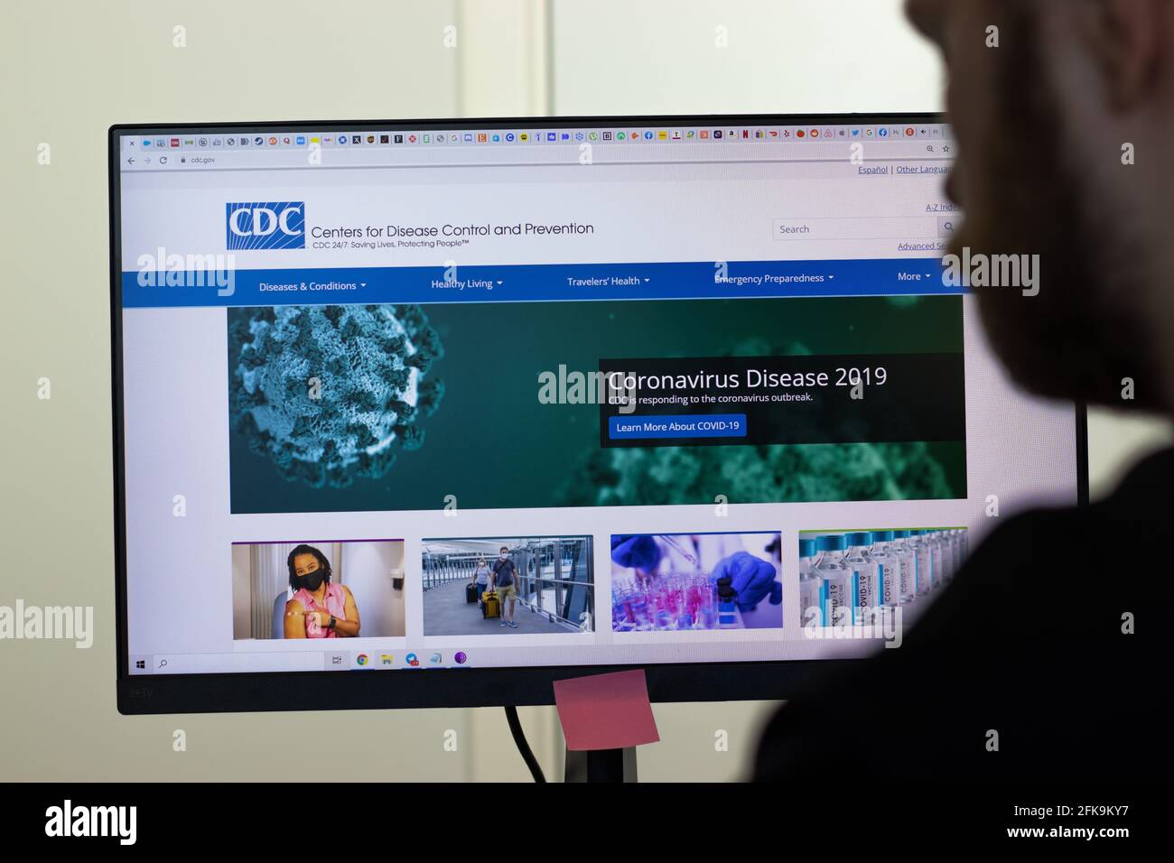 New York, USA - 26 April 2021: CDC website page on screen, man using ...