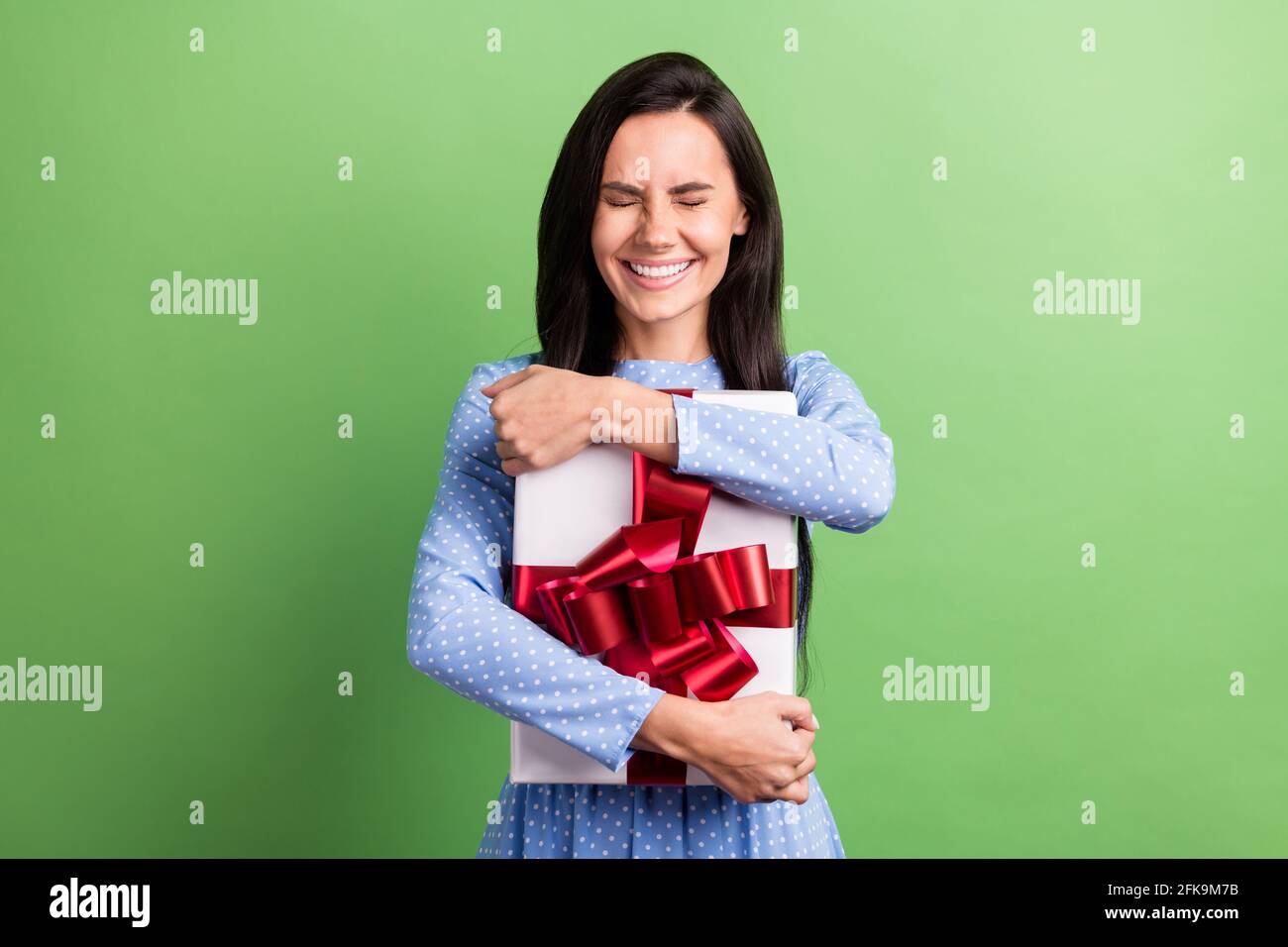 Photo of impressed beauty lady hug present wear blue dress isolated on ...