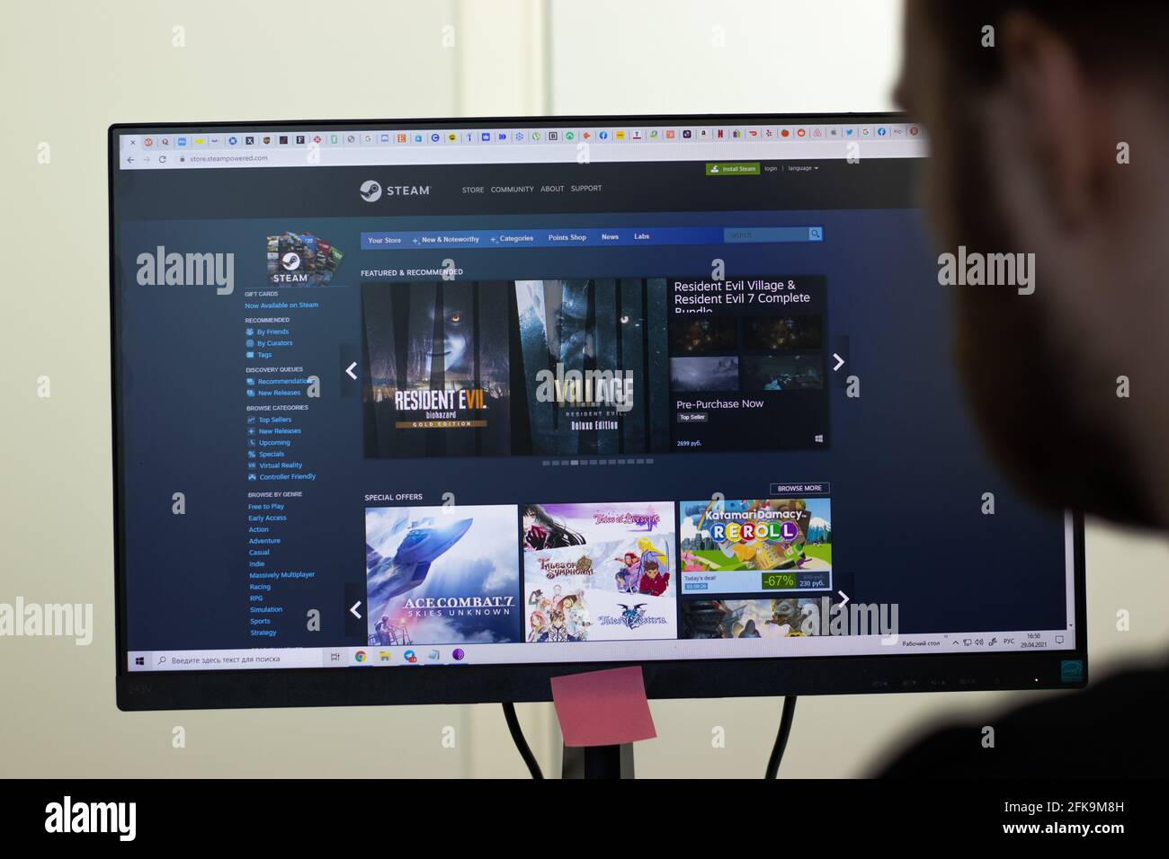 New York, USA - 26 April 2021: Steam website page on screen, man using ...