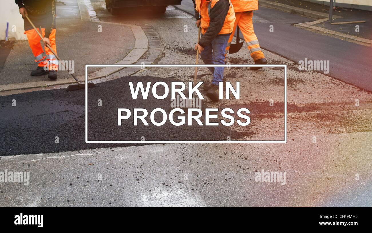 Text "work in progress" with workers as background Stock Photo - Alamy