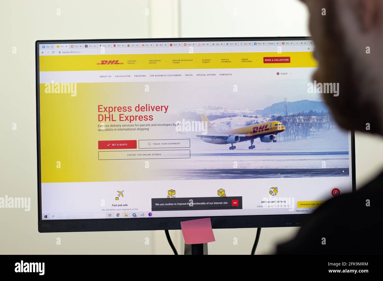 New York, USA - 26 April 2021: DHL website page on screen, man using ...