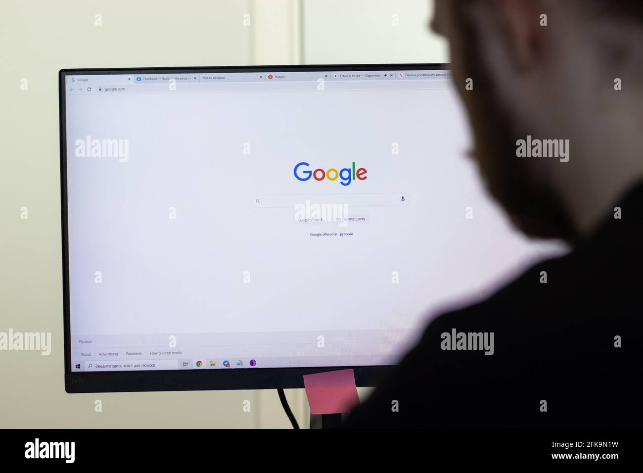 New York, USA - 26 April 2021: Google website page on screen, man using ...