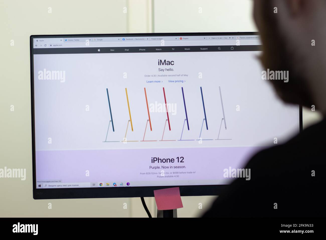 New York, USA - 26 April 2021: Apple website page on screen, man using ...