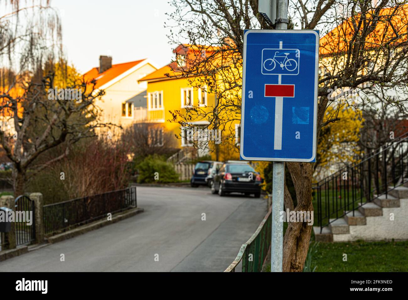 Sign by a street marking dead end continuing as a bike road Stock Photo ...