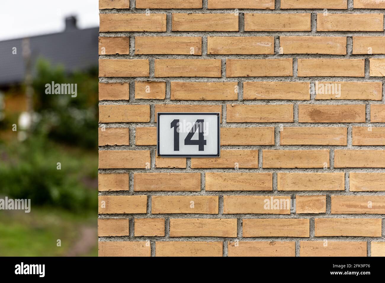 Sign with number 14 on a brick wall Stock Photo - Alamy