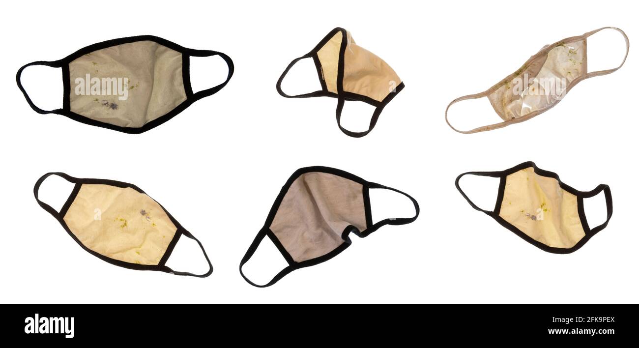Six different soiled and/or damaged cloth face masks isolated on white ...