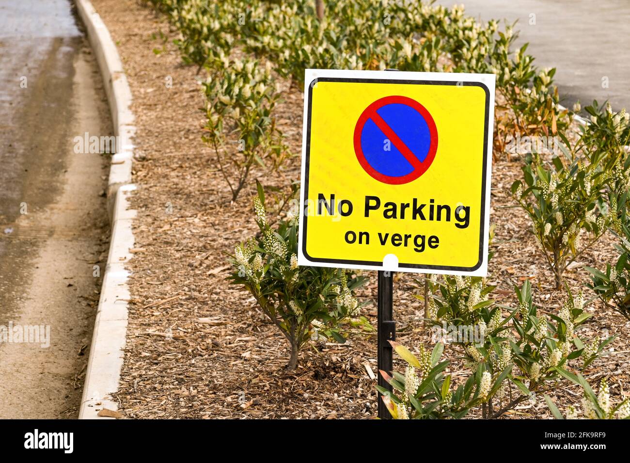 No parking sign on the verge of a road where new shrubs have been ...