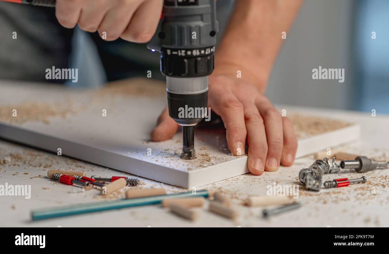 Man working during process of furniture manufacturing Stock Photo - Alamy