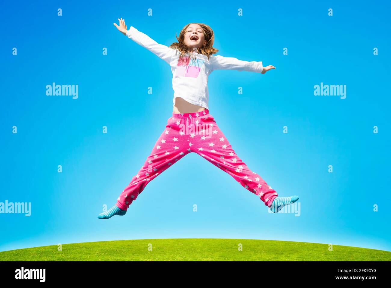 Happy girl jumping blue sky hi-res stock photography and images - Alamy
