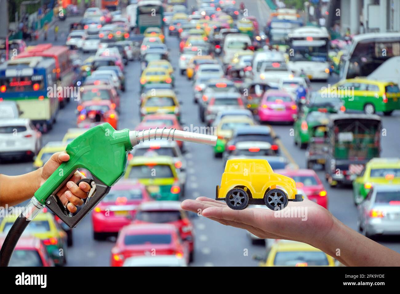 Left hands of men who were holding an automatic nozzle to make refill ...