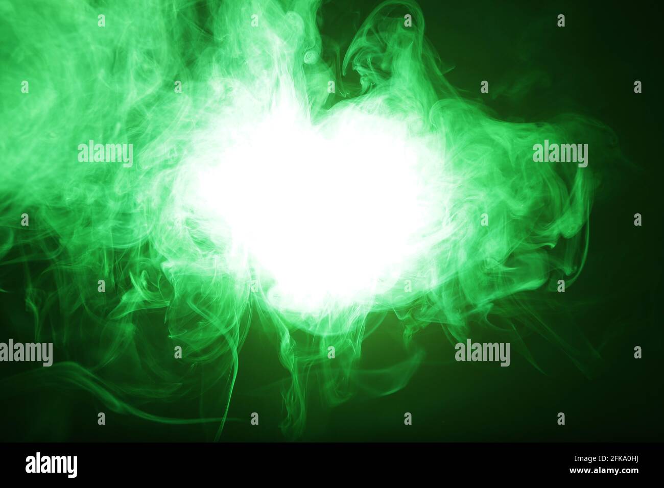 Artificial smoke is illuminated with green bright light Stock Photo - Alamy