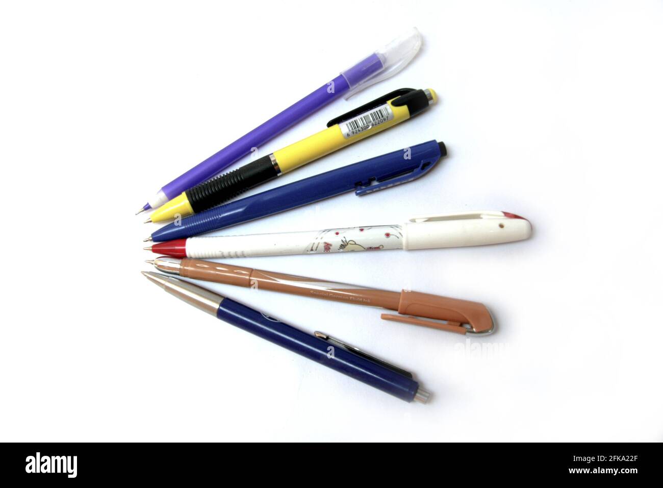 Overhead shot of pens of different brands and design on an isolated ...